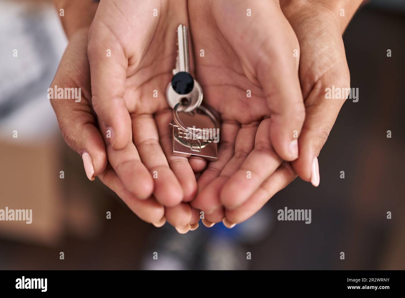 Woman and girl mother and daughter hands holding key at new home Stock ...