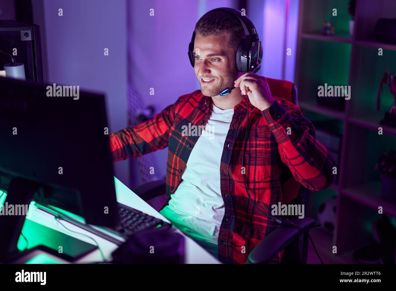 Young caucasian man streamer playing video game using computer at ...