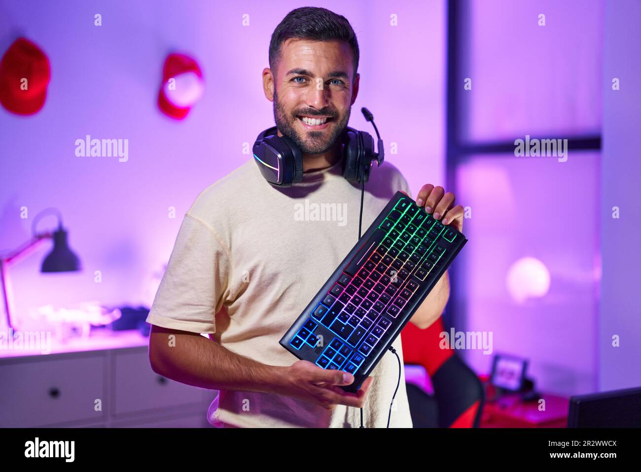 Young hispanic man streamer smiling confident holding keyboard computer ...