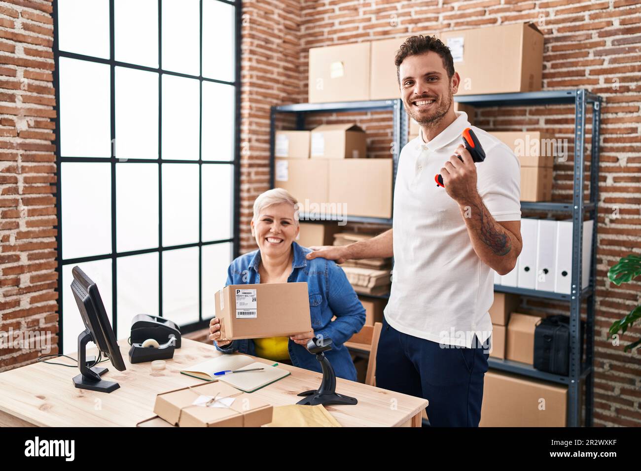 Mother and son ecommerce business workers scanning package at office ...