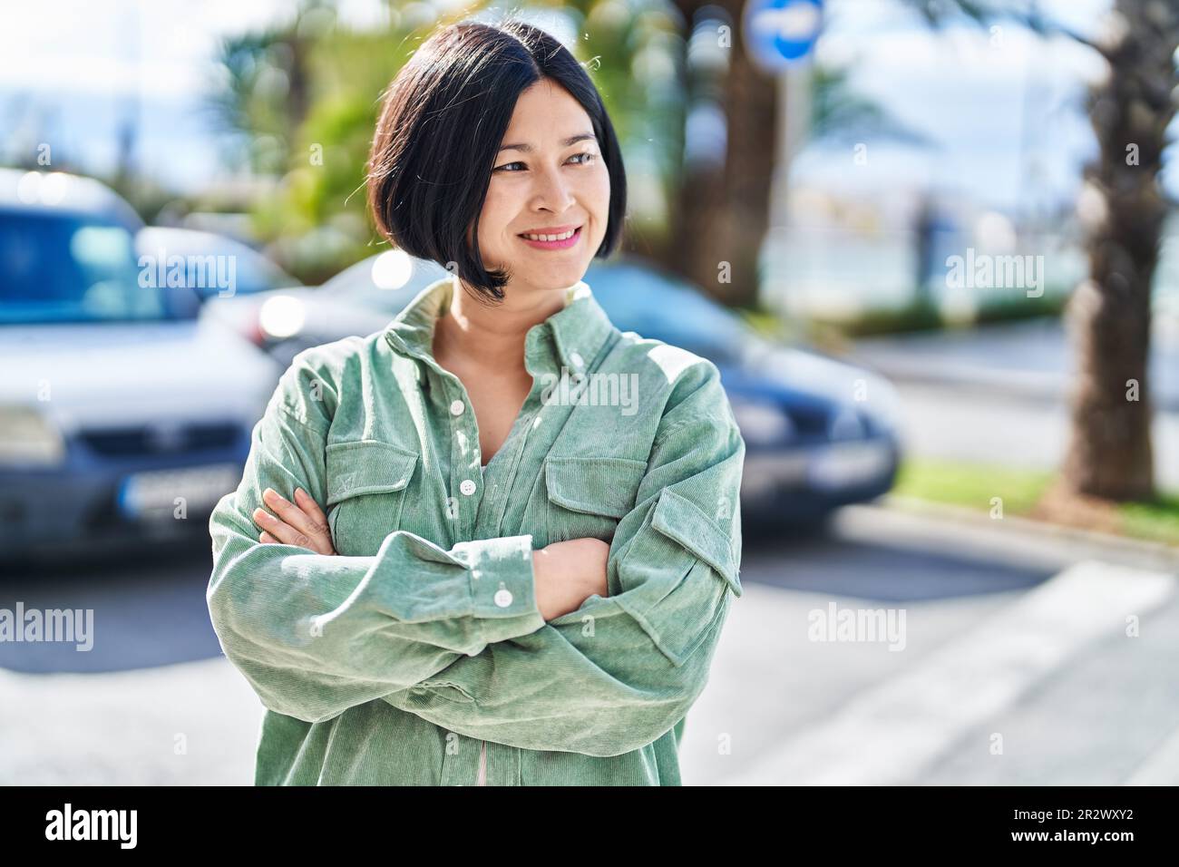 Young chinese woman smiling confident standing with arms crossed ...