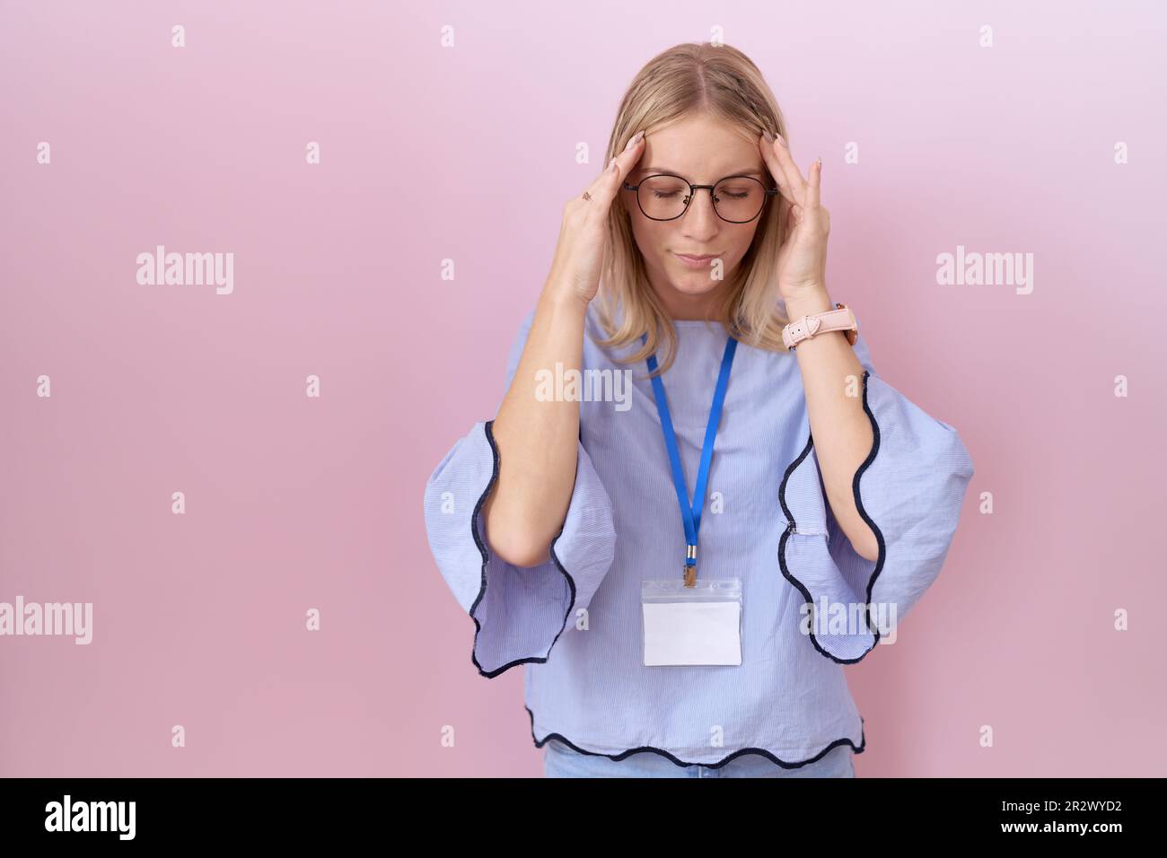 Young caucasian business woman wearing id card with hand on head ...