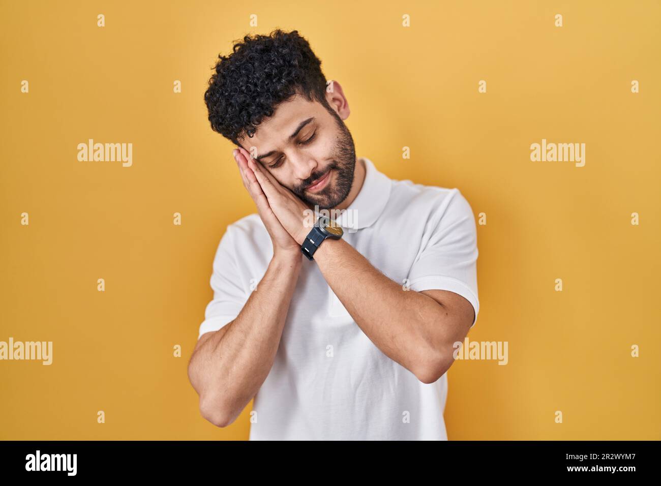 Arab man standing over yellow background sleeping tired dreaming and ...