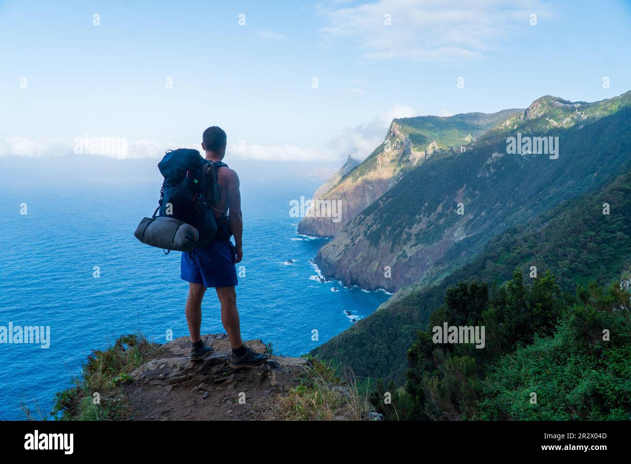 A young man looking at the landscape of Ponta de Sao Lourenco from the ...