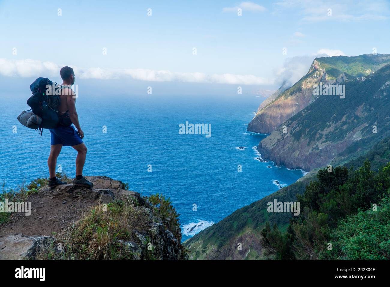 A young man looking at the landscape of Ponta de Sao Lourenco from the ...