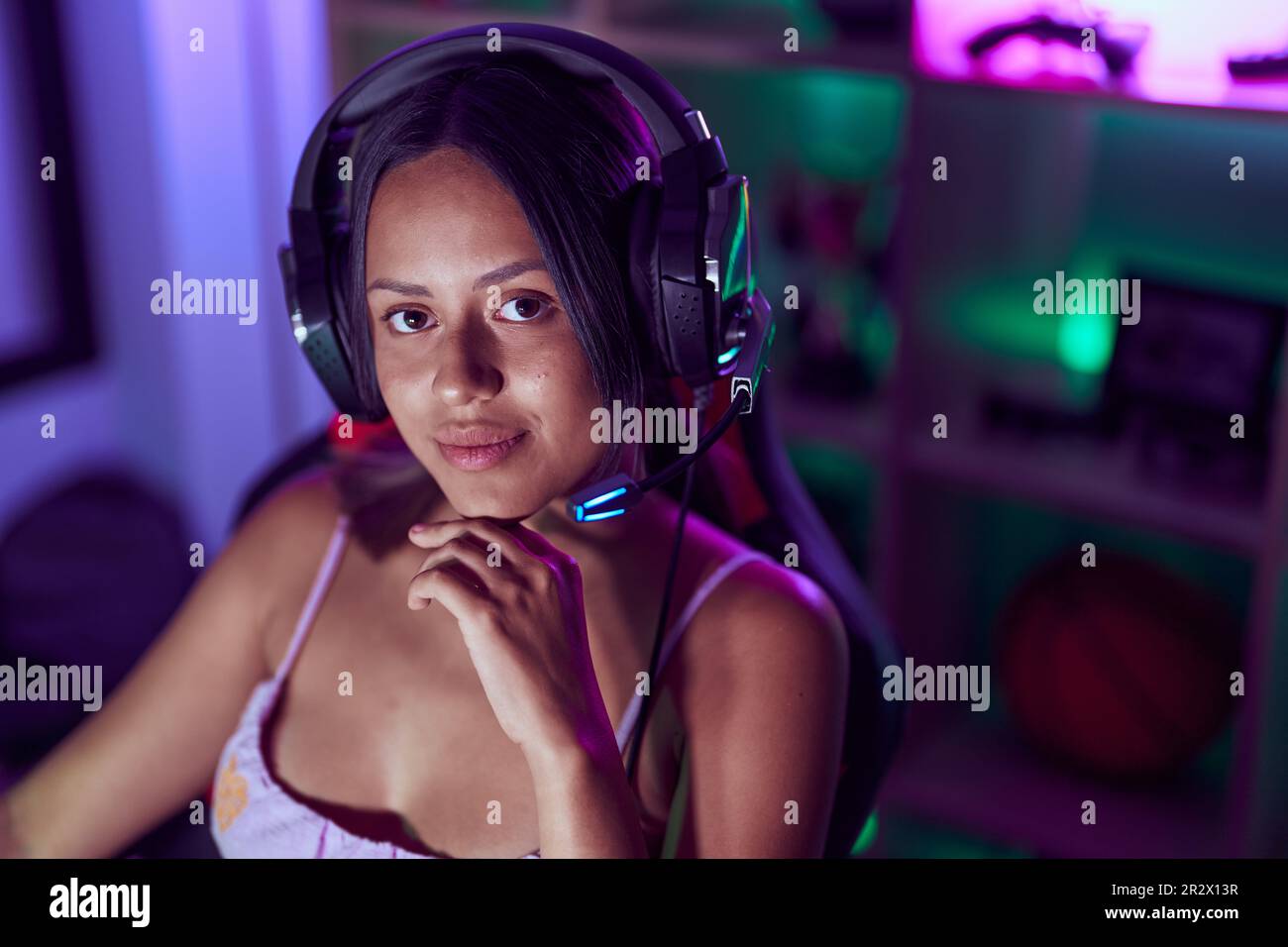 Young hispanic woman streamer playing video game at gaming room Stock ...