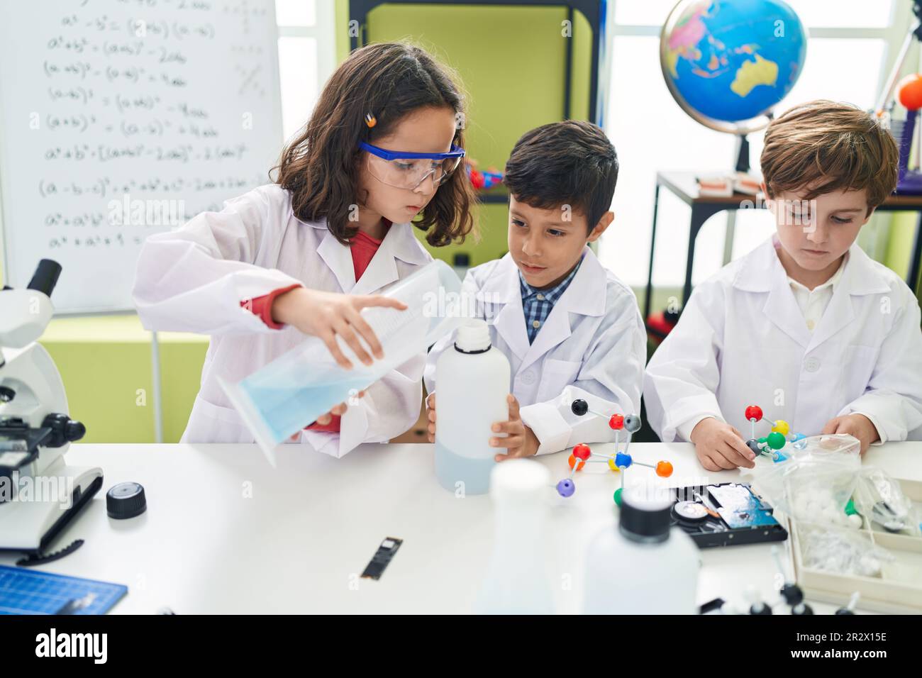 Group of kids students pouring liquid on bottl doing experiment at ...