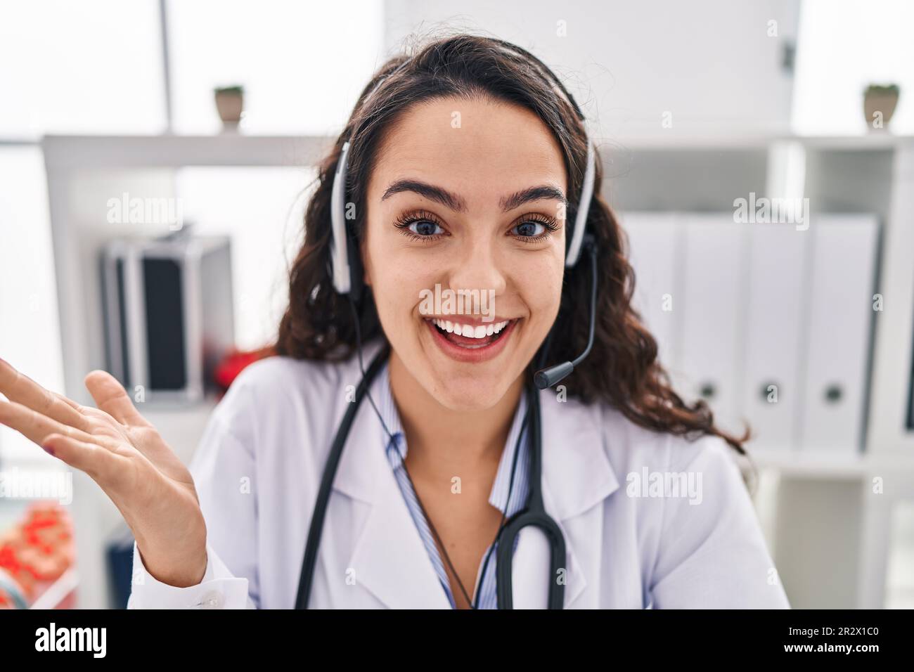 Young doctor woman working on online appointment celebrating achievement with happy smile and ...