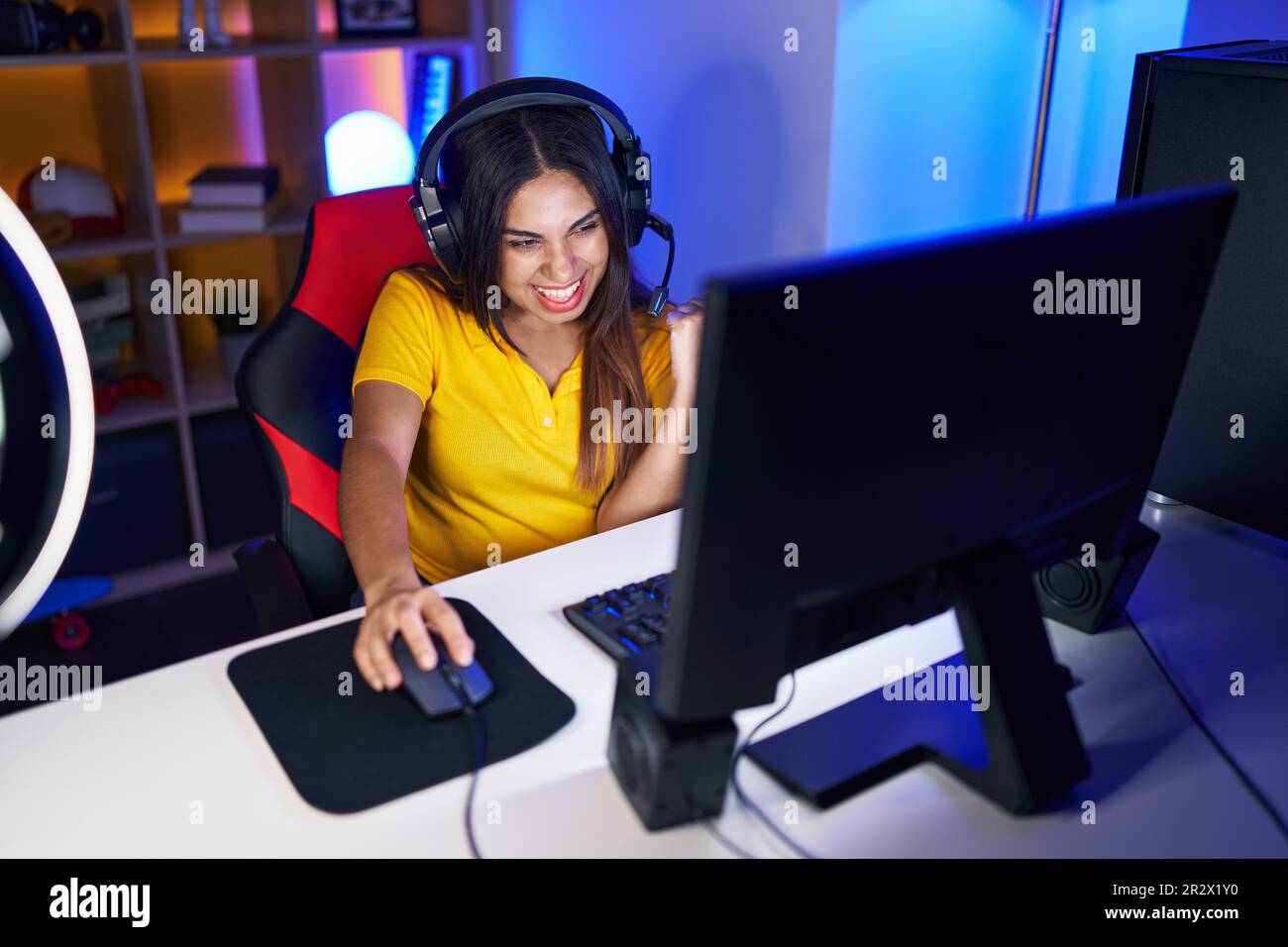 Young beautiful arab woman streamer playing video game with winner ...