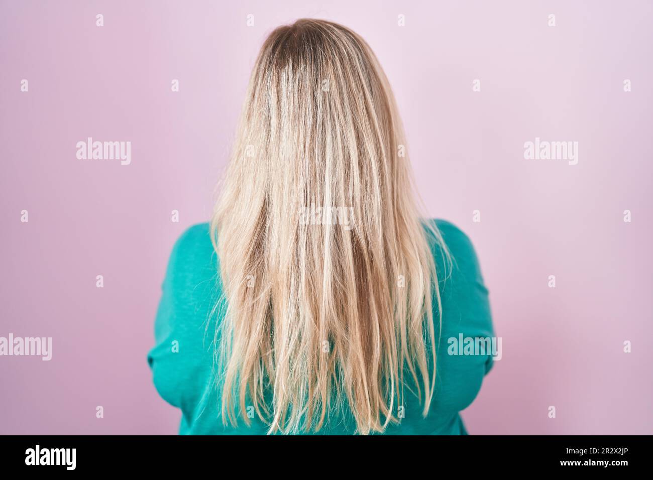 Caucasian plus size woman standing over pink background standing ...