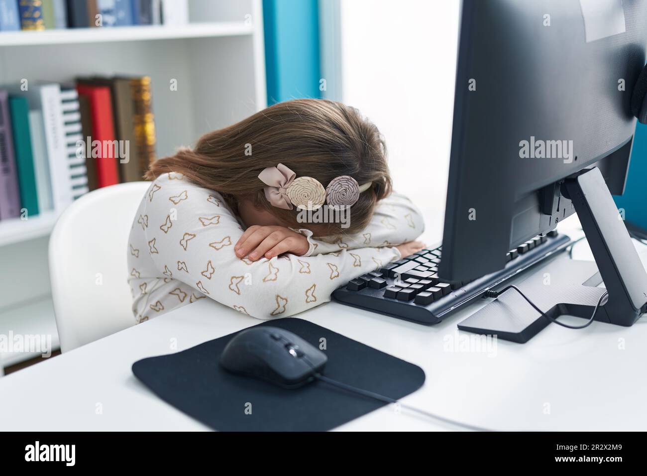 Adorable blonde girl student stressed using computer at classroom Stock ...