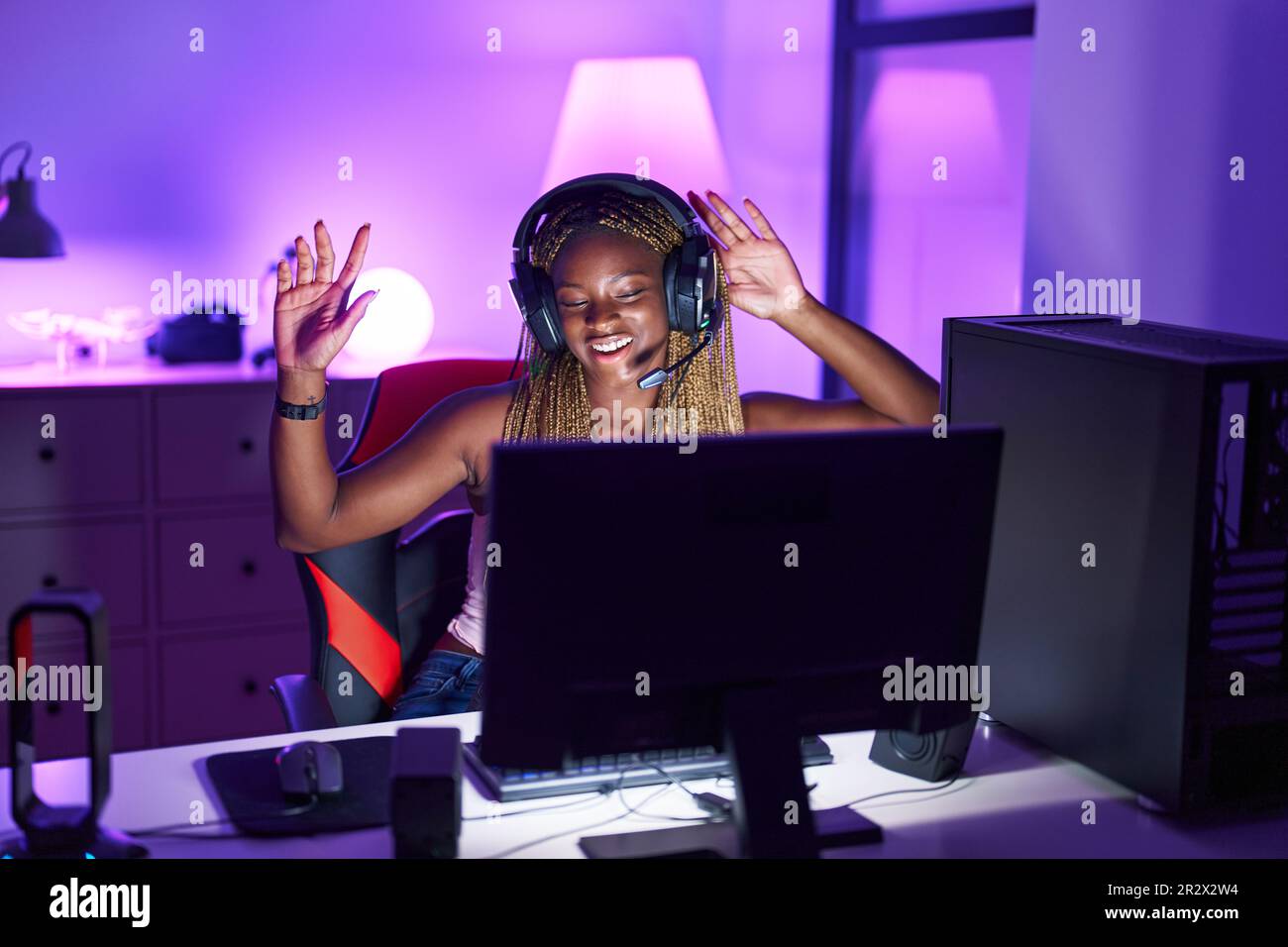 African american woman streamer listening to music and dancing at ...