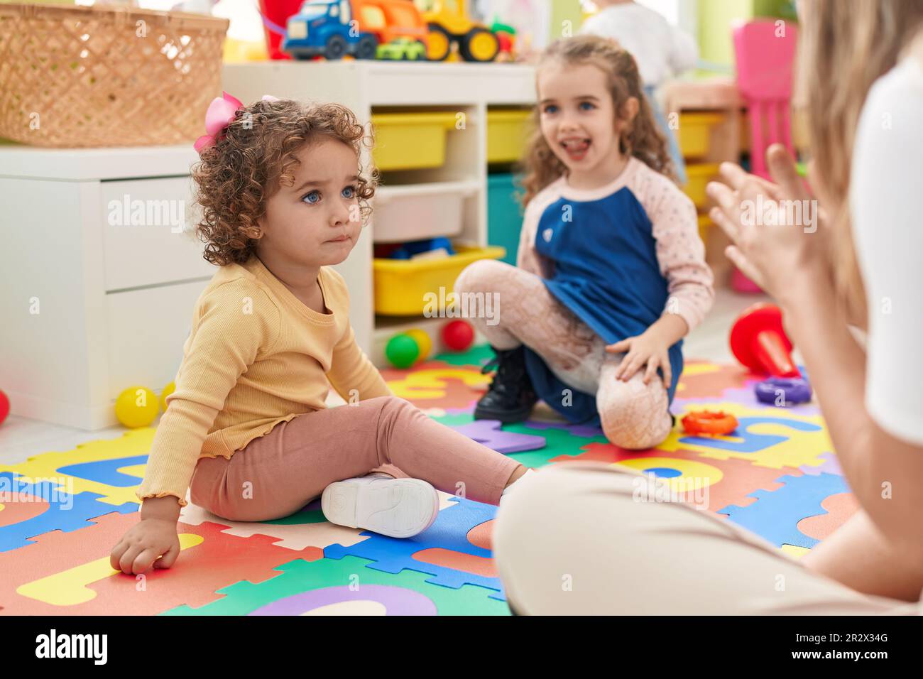 Adorable girls smiling confident sitting on floor at kindergarten Stock Photo - Alamy