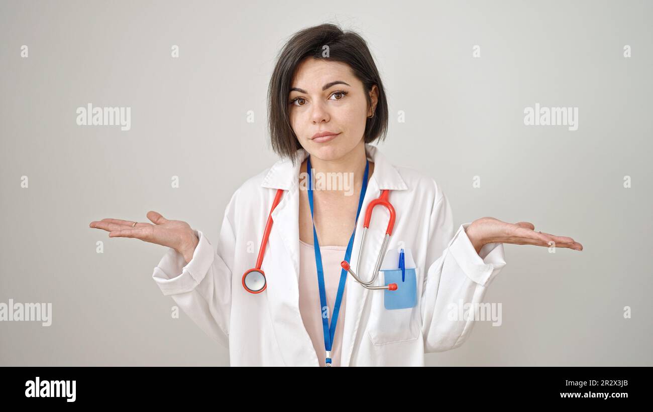 Young caucasian woman doctor standing with doubt expression with arms ...