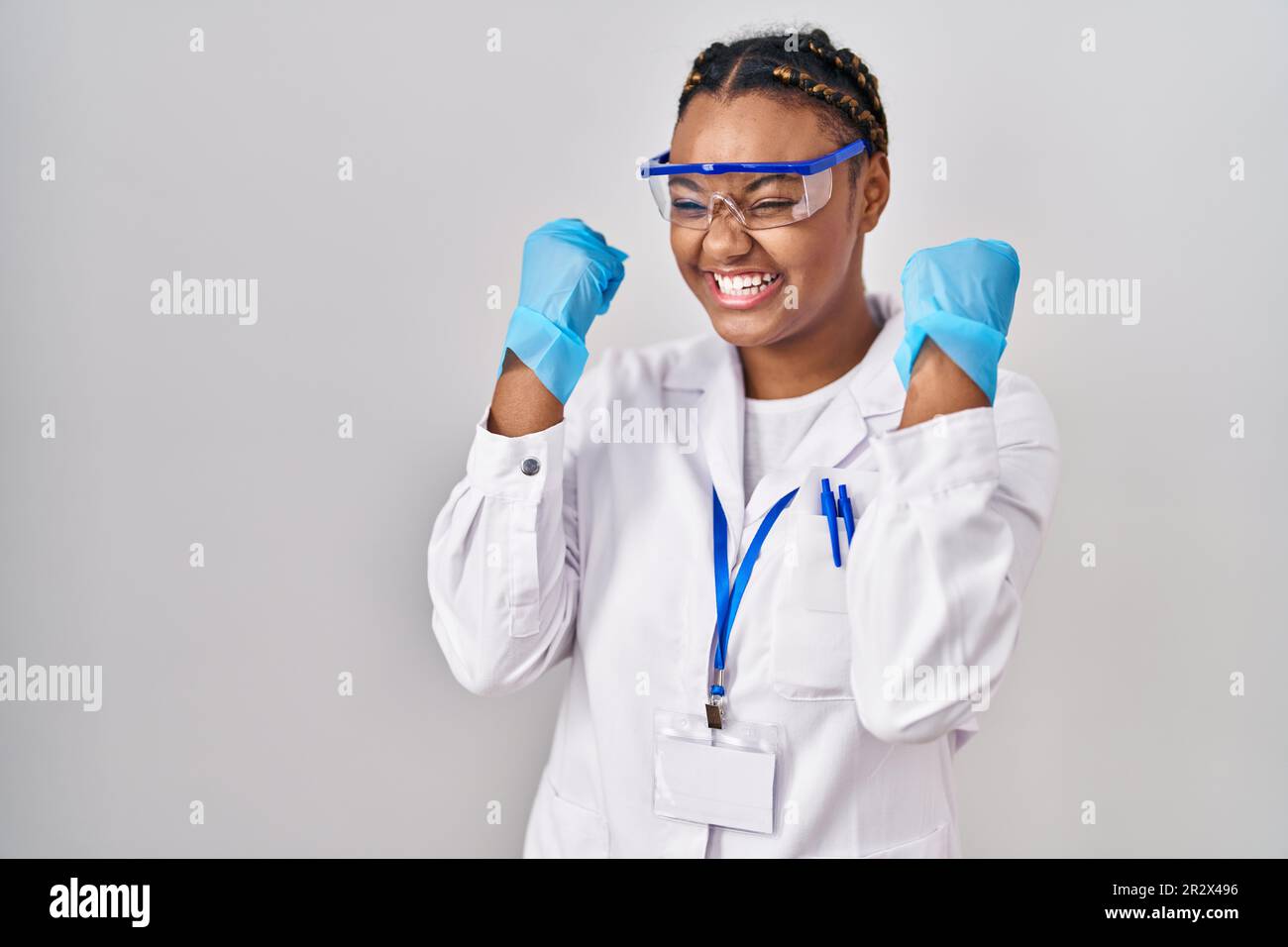 African american woman with braids wearing scientist robe very happy ...
