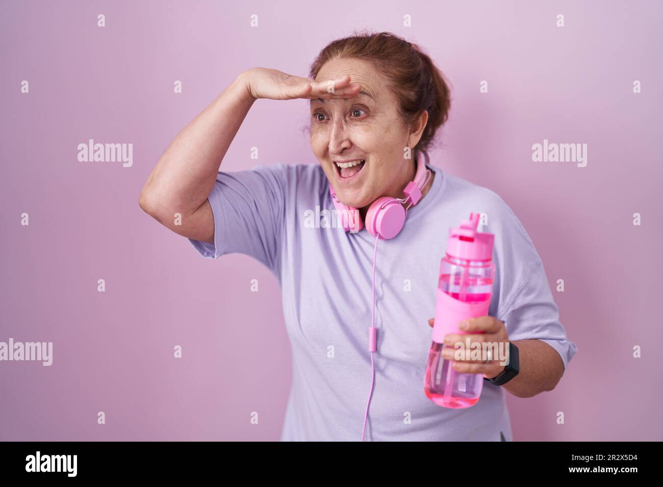 Senior woman wearing sportswear and headphones very happy and smiling ...