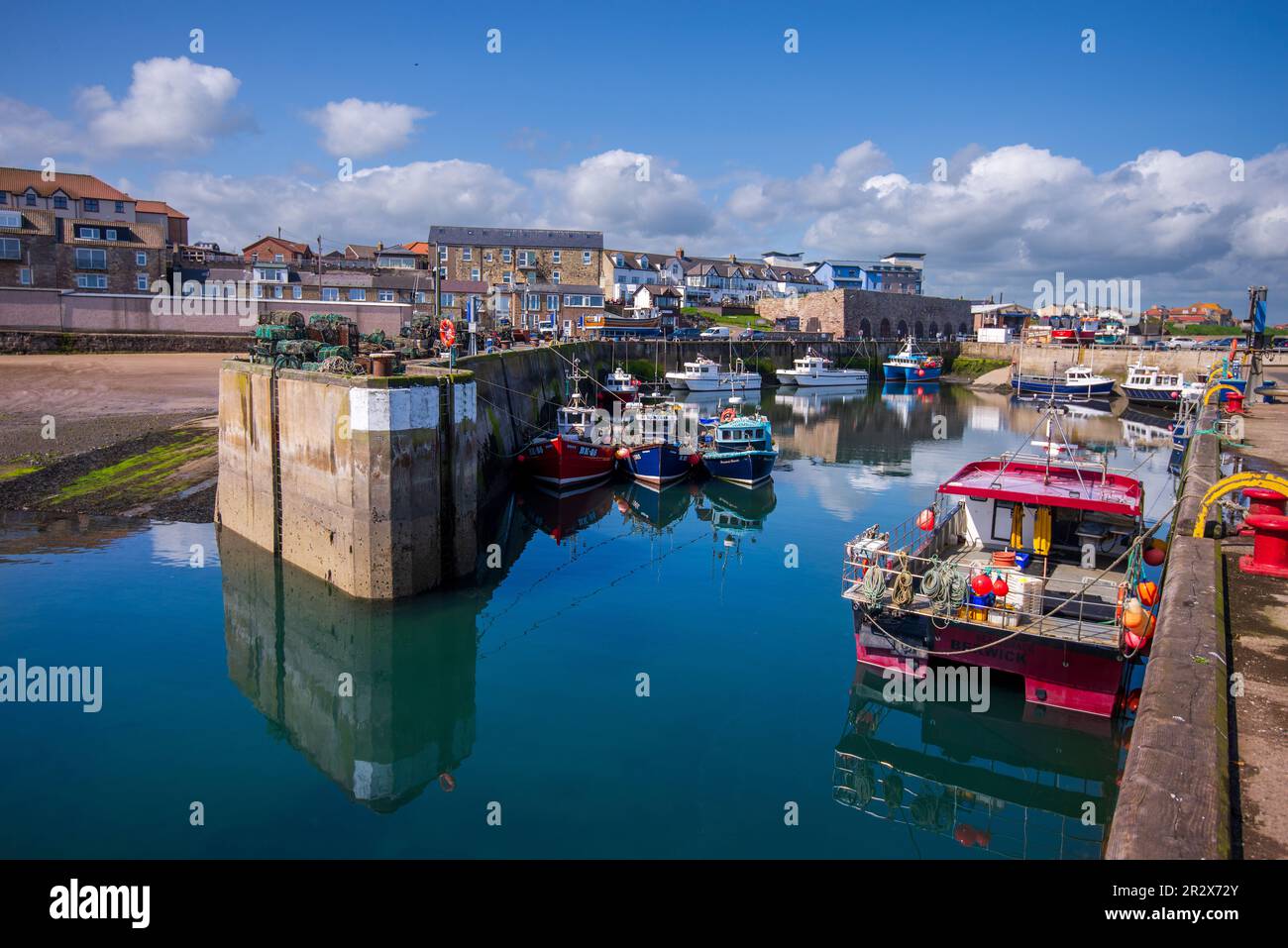 The harbour at low tide at Seahouses on the north east coast of England ...