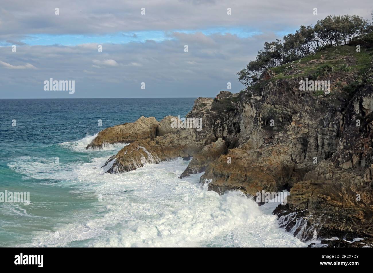 sea breaking on rocky headland Point Lookout, North Stradbroke Island ...