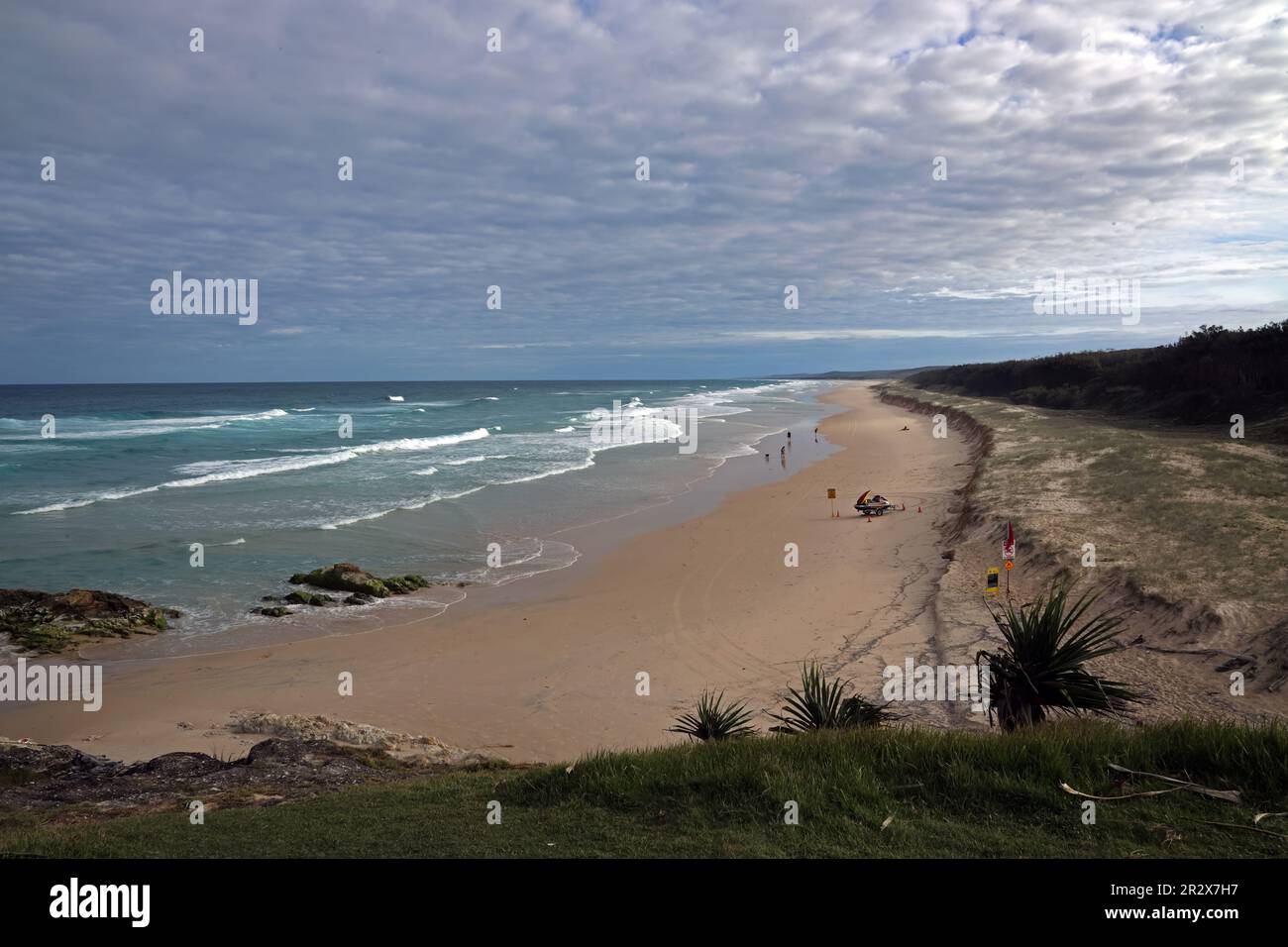 view along beach under a cloudy sky Main Beach, North Stradbroke Island ...