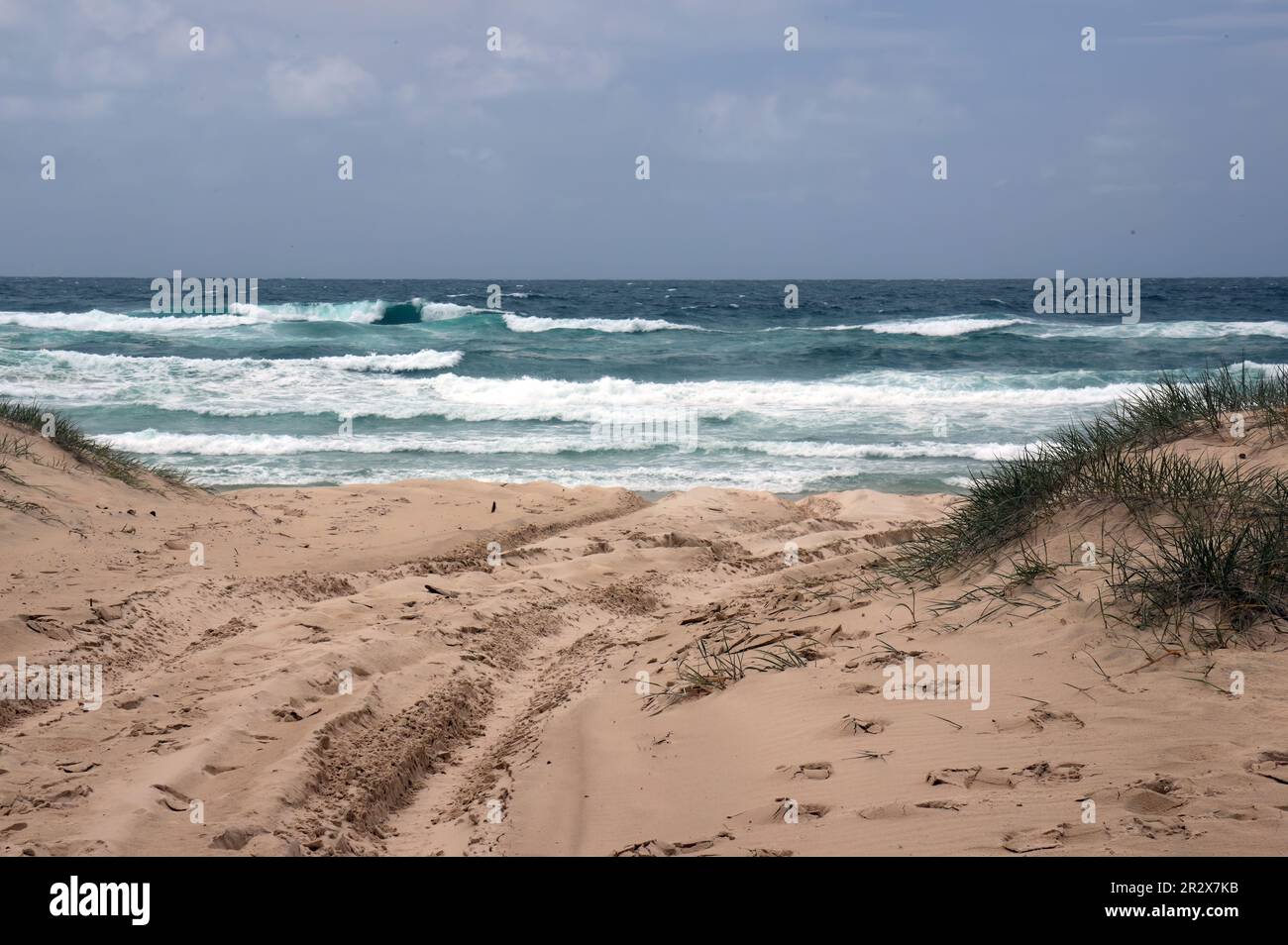 view overe beach under a stormy sky Main Beach, North Stradbroke Island ...