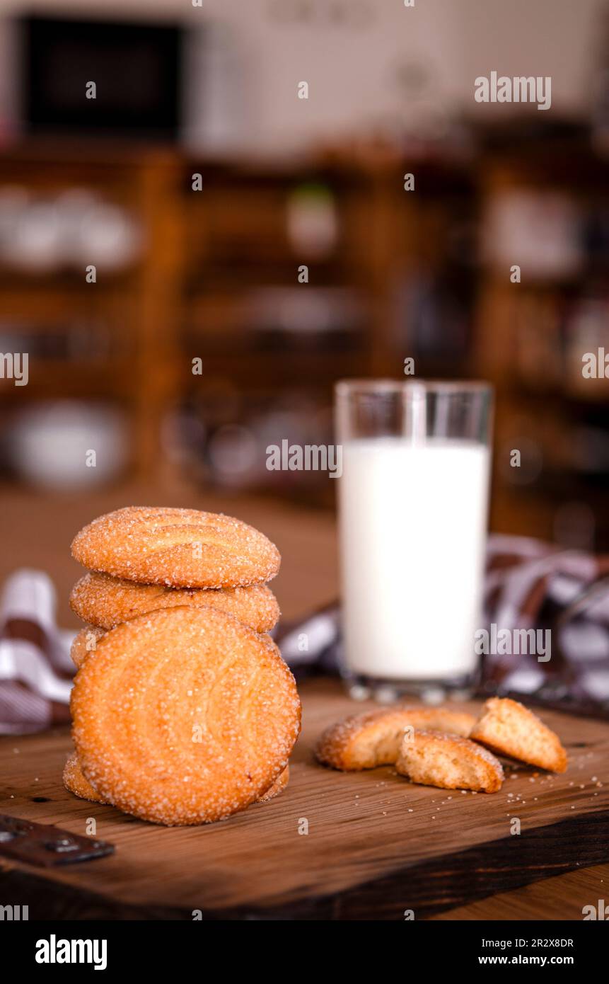 Homemade biscuits with a glass of milk on a wooden board. Homemade ...
