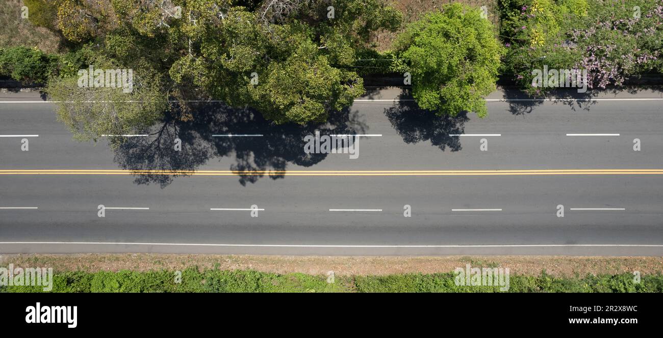 Highway road covered with tree shadow above top drone view Stock Photo ...