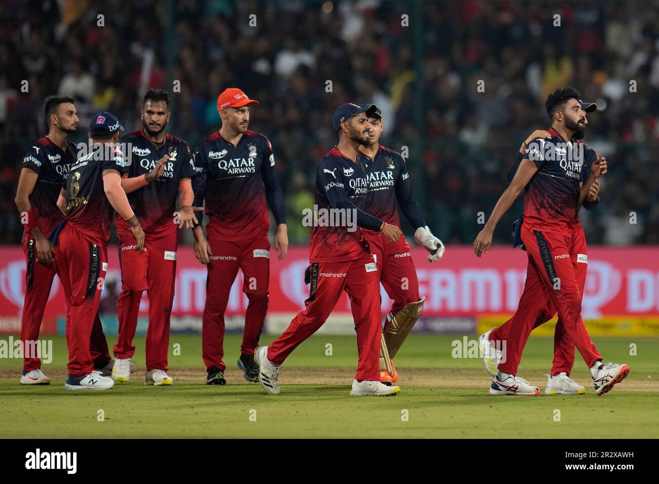 Royal Challengers Bangalore's players celebrate the wicket of Gujarat ...