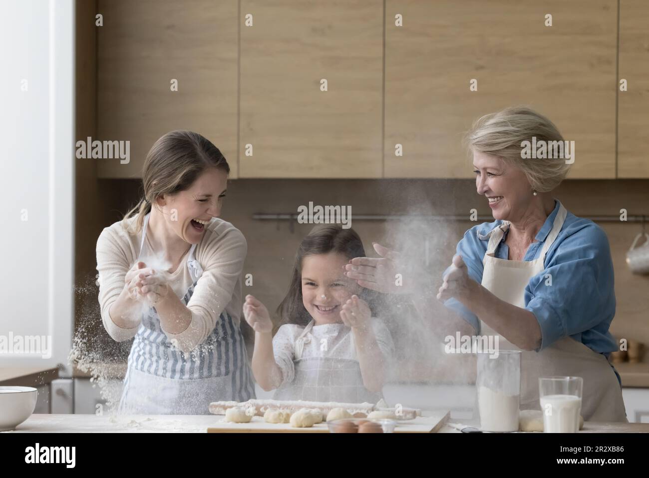 Multigenerational family having fun while prepare pastries in the ...