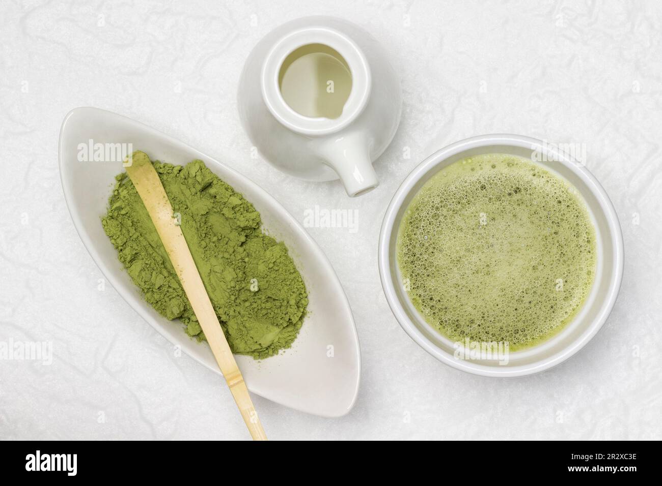 Matcha green tea in a bowl. Bamboo measuring spoon in a bowl of matcha ...
