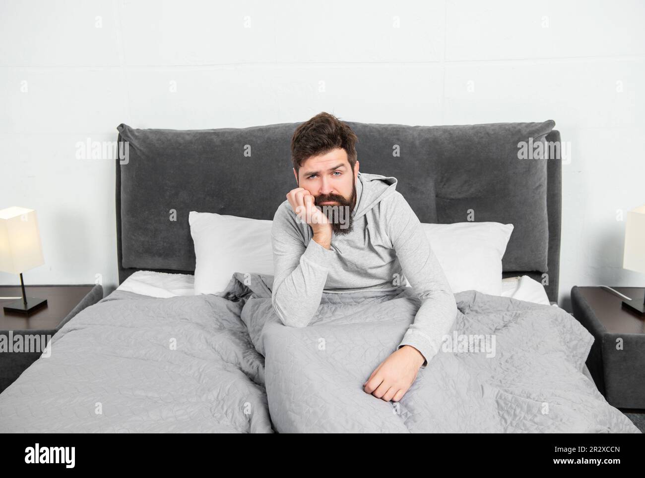 Sleepy guy feeling drowsy being in bed awake after sleep, morning Stock ...