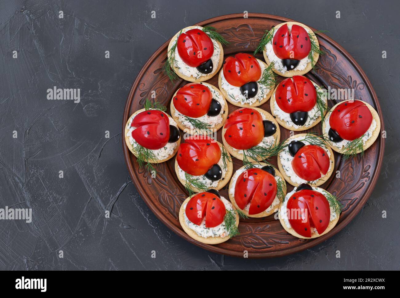 Funny Snack on crackers ladybug-shaped of tomato, Closeup, Top view ...