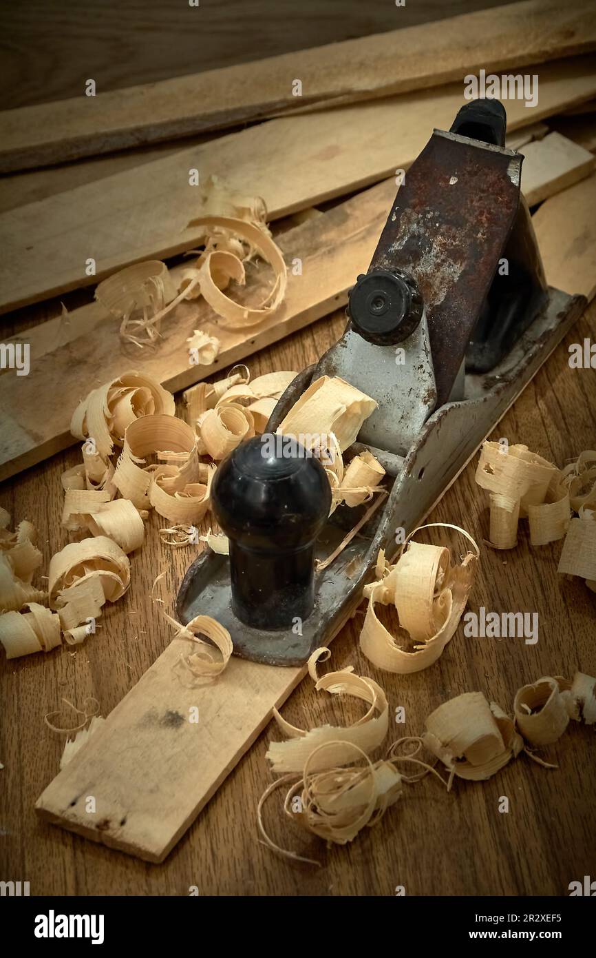 Planer and shavings after planing wooden boards on the workbench ...