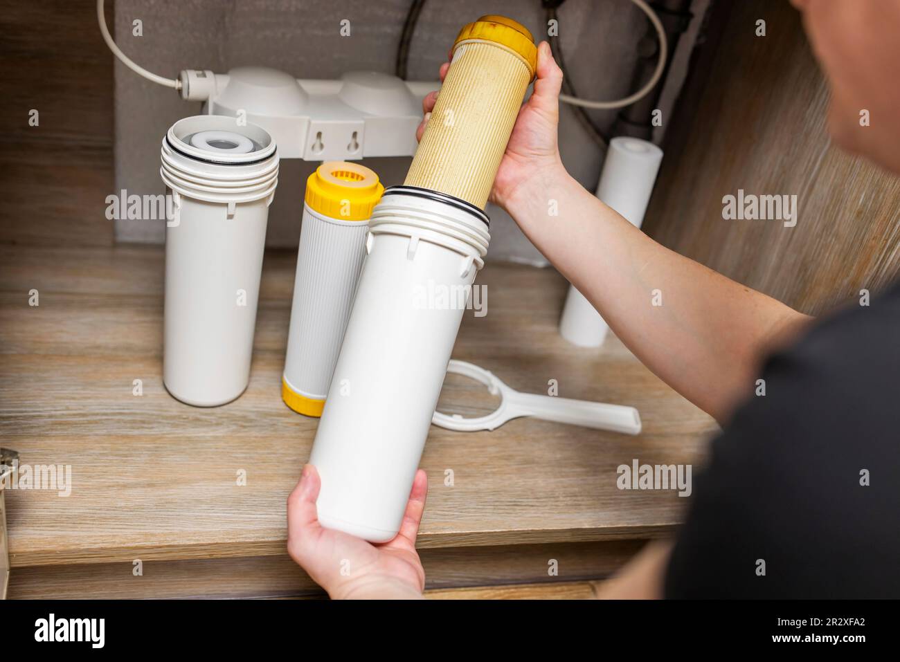 Plumber installs or change water filter. Replacement aqua filter Stock ...