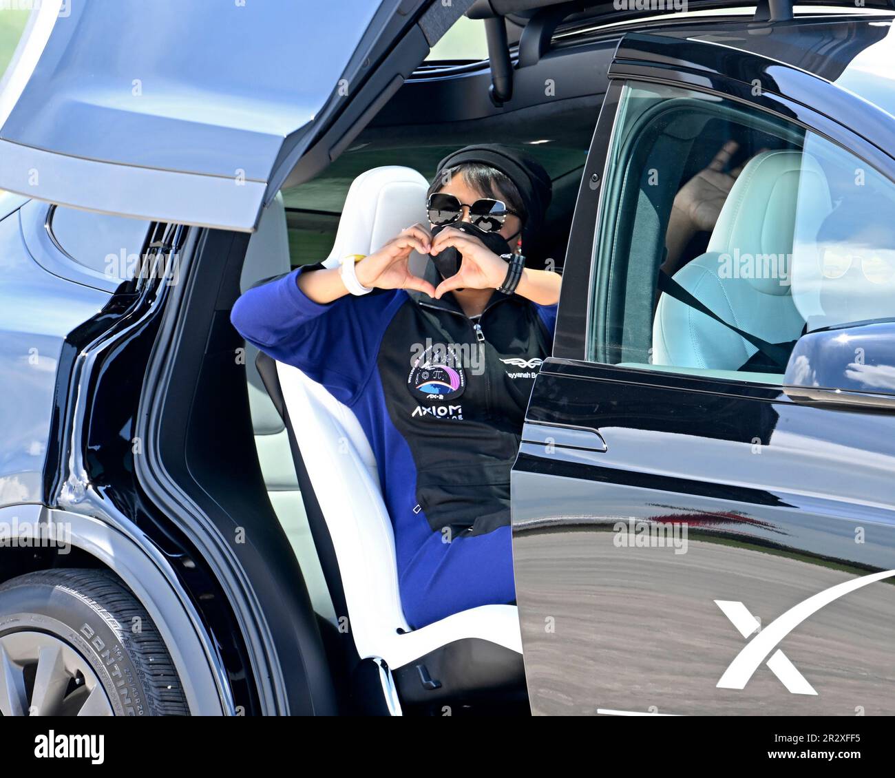 Rayyannah Barnawi gives a heart sign as the door to her Tesla Crew ...