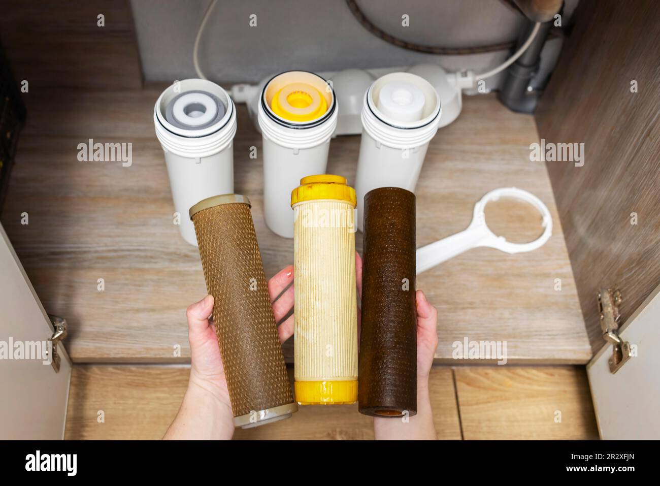 Plumber installs or change water filter. Replacement aqua filter Stock ...