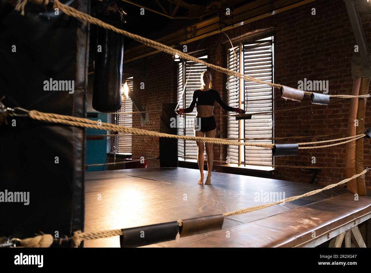 Woman fighter girl power. Woman fighter jumping rope on boxing ring ...