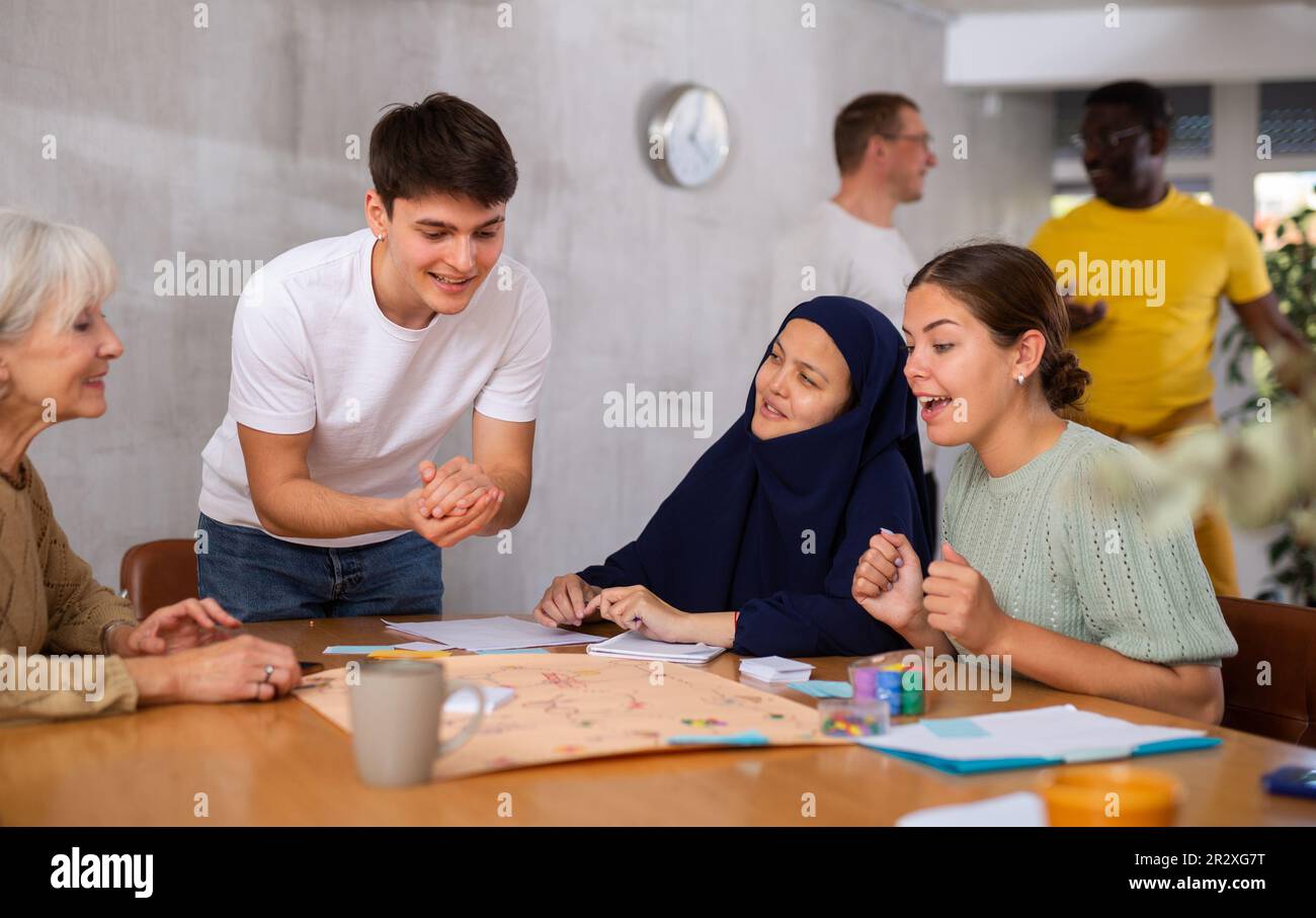 Group of of different years people playing tabletop game Stock Photo ...