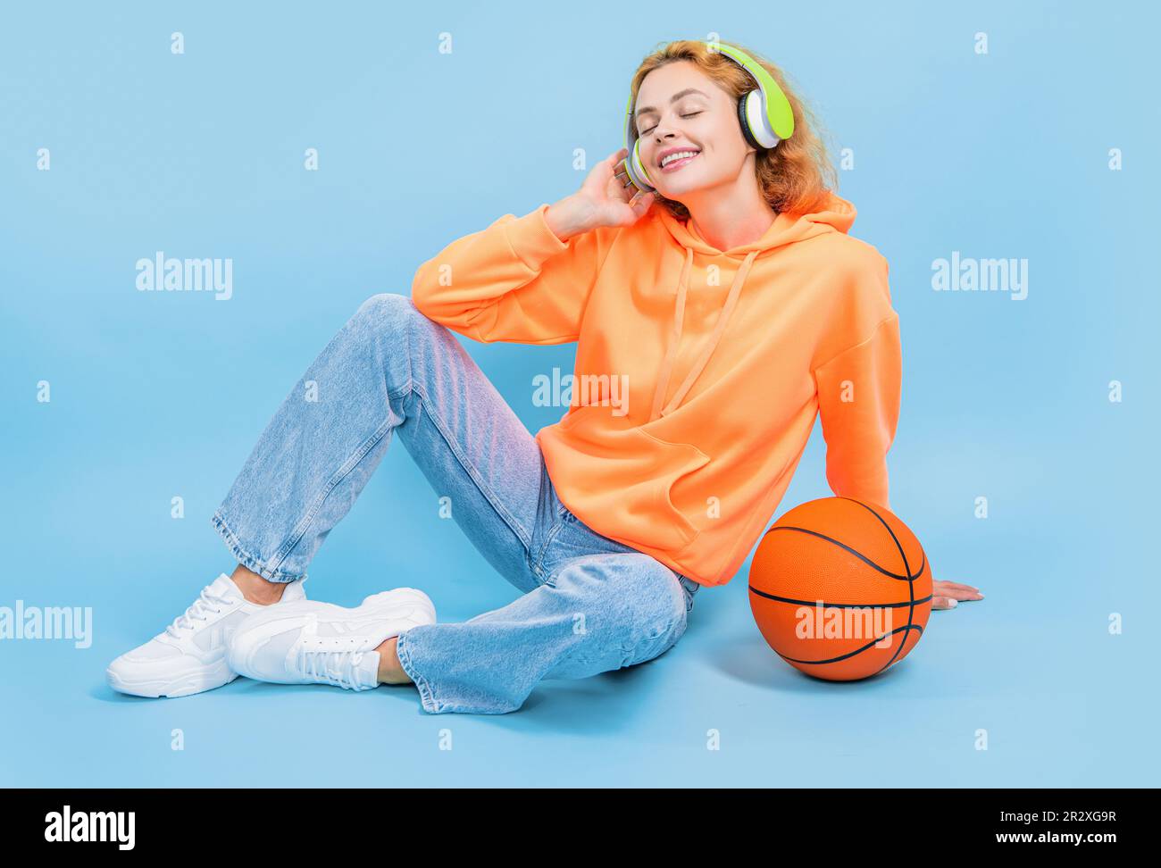 glad redhead basketball woman player on color background. basketball ...