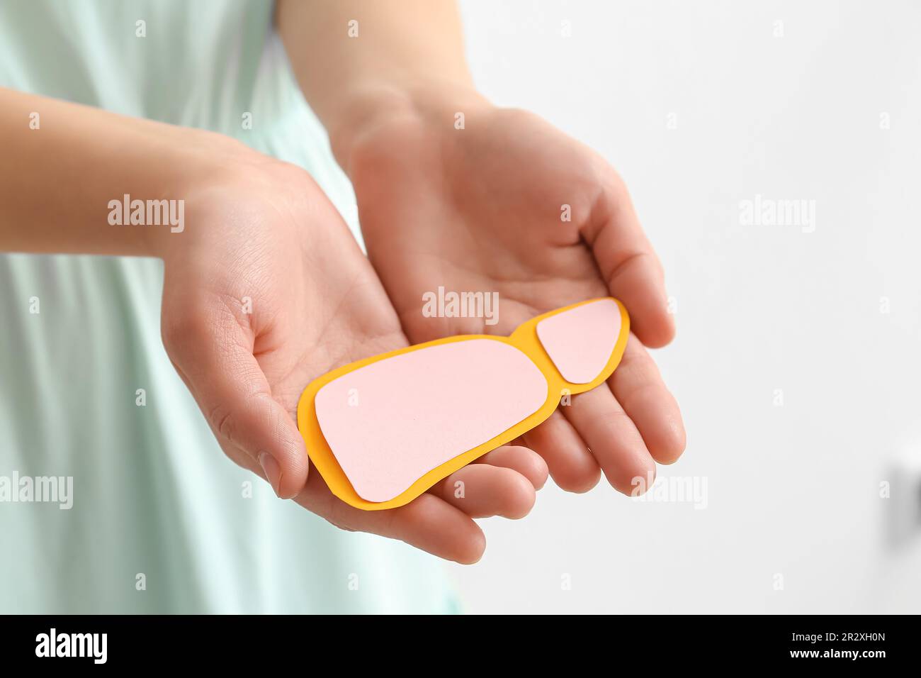 Woman holding pink liver on white background Stock Photo - Alamy