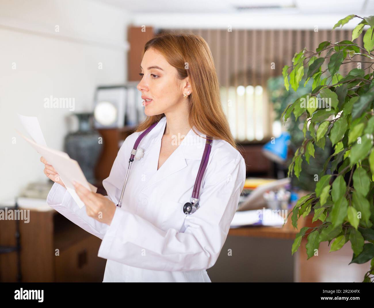 Female doctor reviewing medical history of patient in office Stock ...