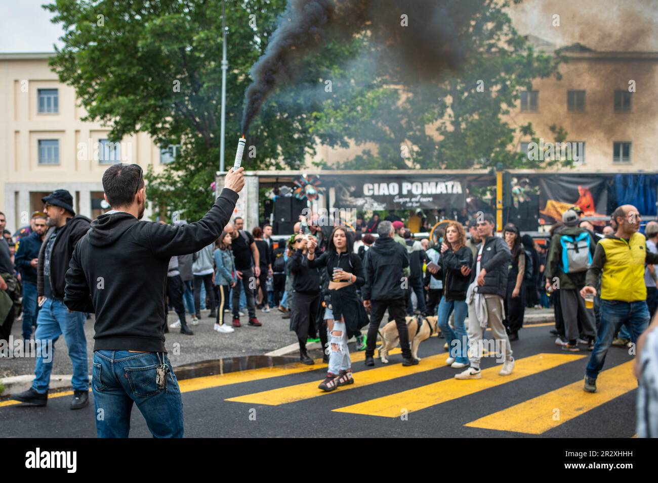 A protester with a black smoke bomb in his hand during the rave street ...