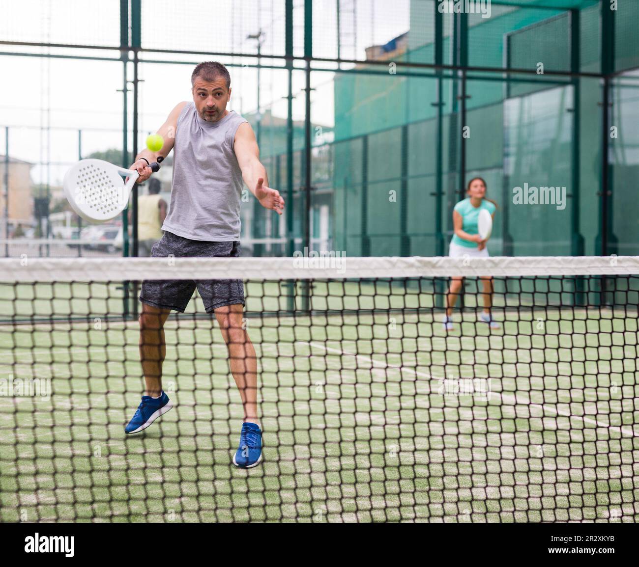 Doubles play in an outdoor paddle game court Stock Photo - Alamy