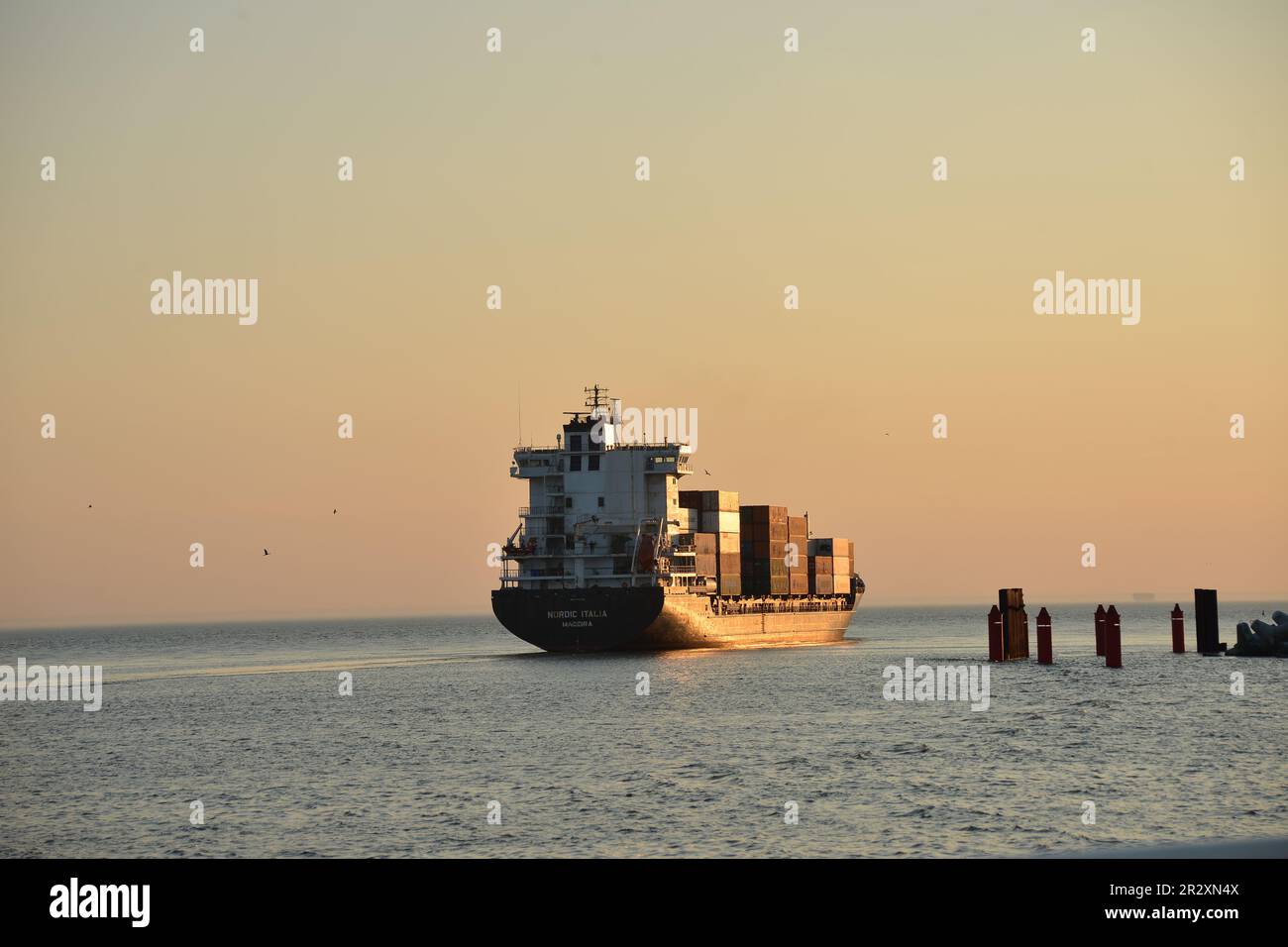 Cargo ship vessel leaving port Stock Photo - Alamy
