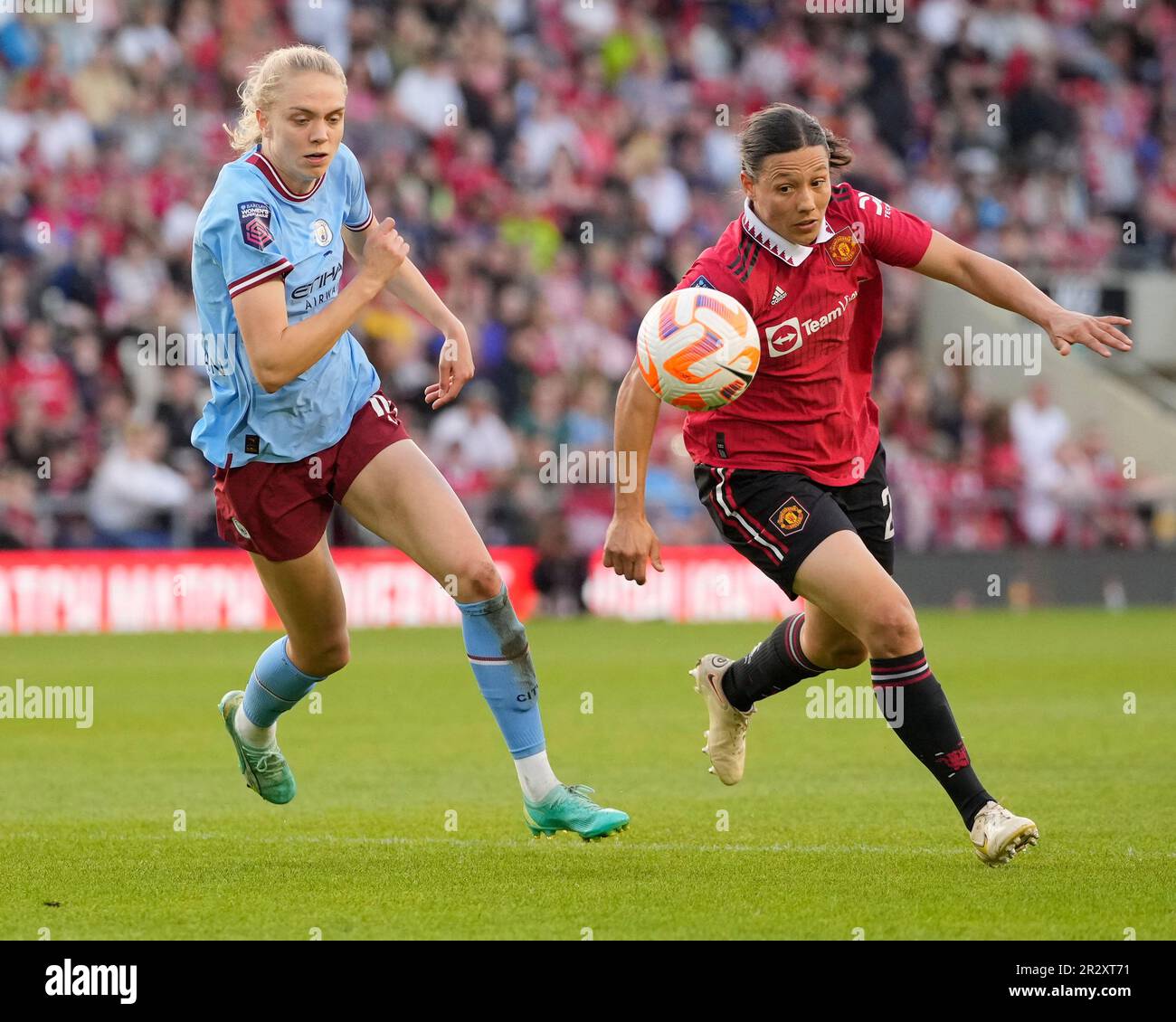 Rachel Williams #28 of Manchester United chases a ball with Esme Morgan ...