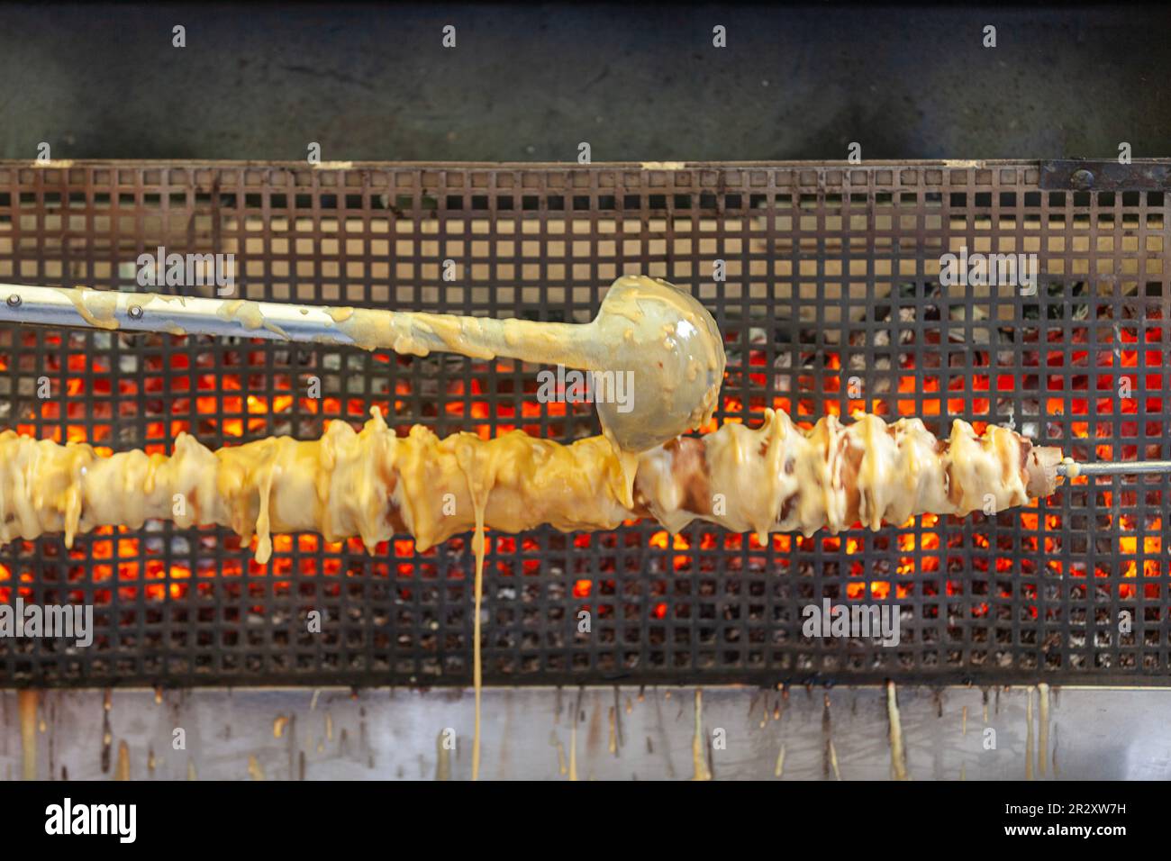 A French spit cake consisting of layers of dough placed, one at a time ...