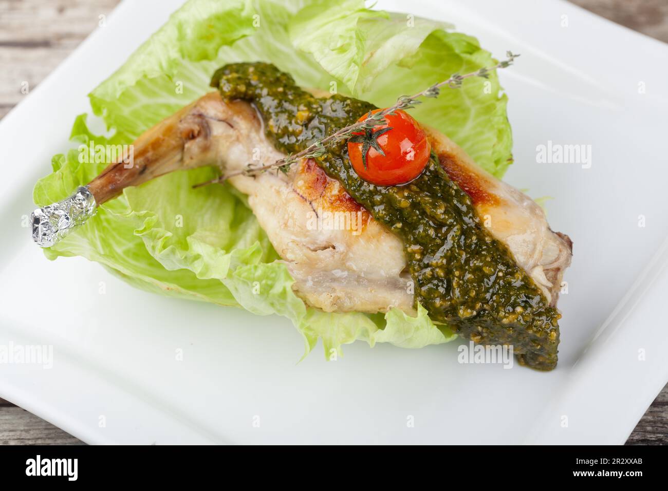 Oven Baked rabbit legs with sauce Stock Photo - Alamy