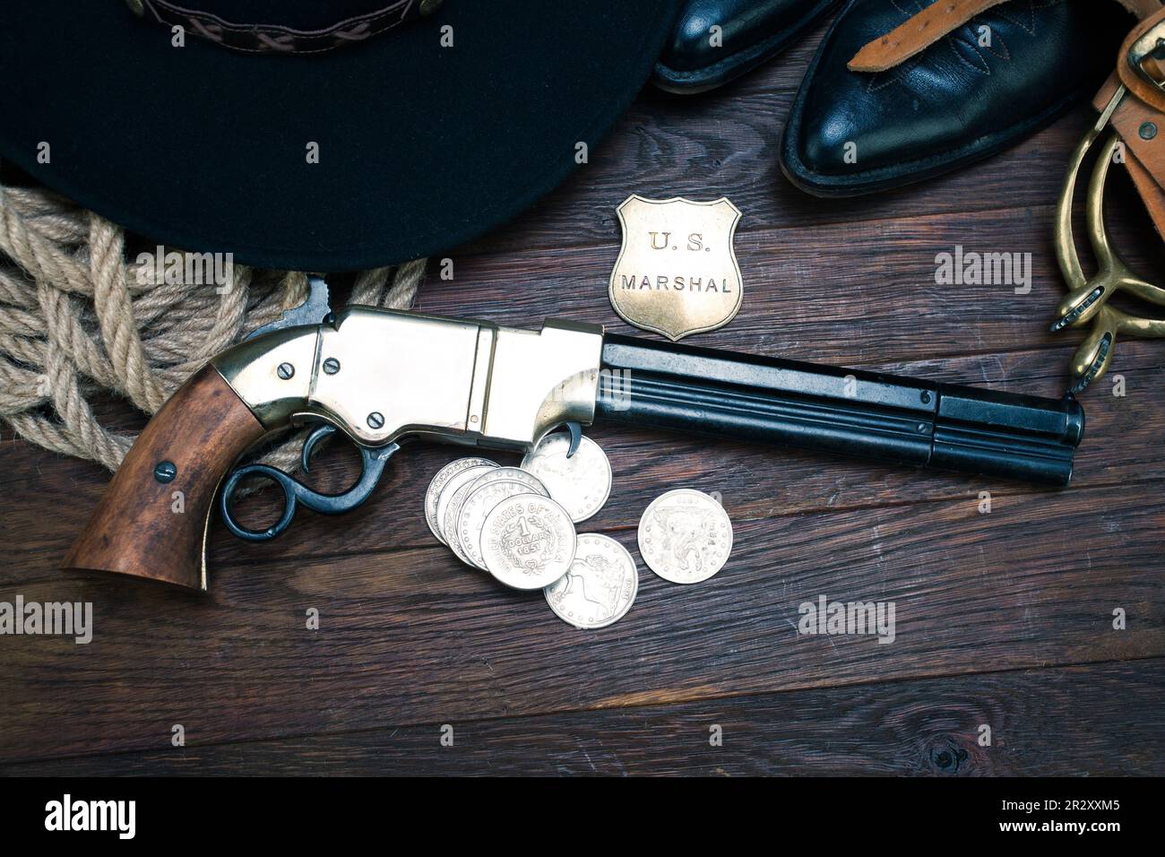 Old West gun with U.S. Marshal badge and silver dollars with hat, rope ...