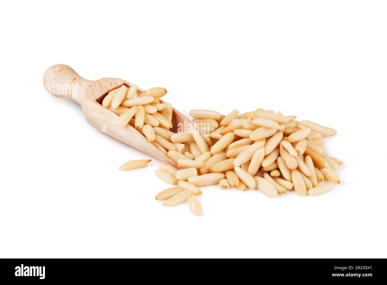 wooden scoop with pine nuts on a white background Stock Photo - Alamy