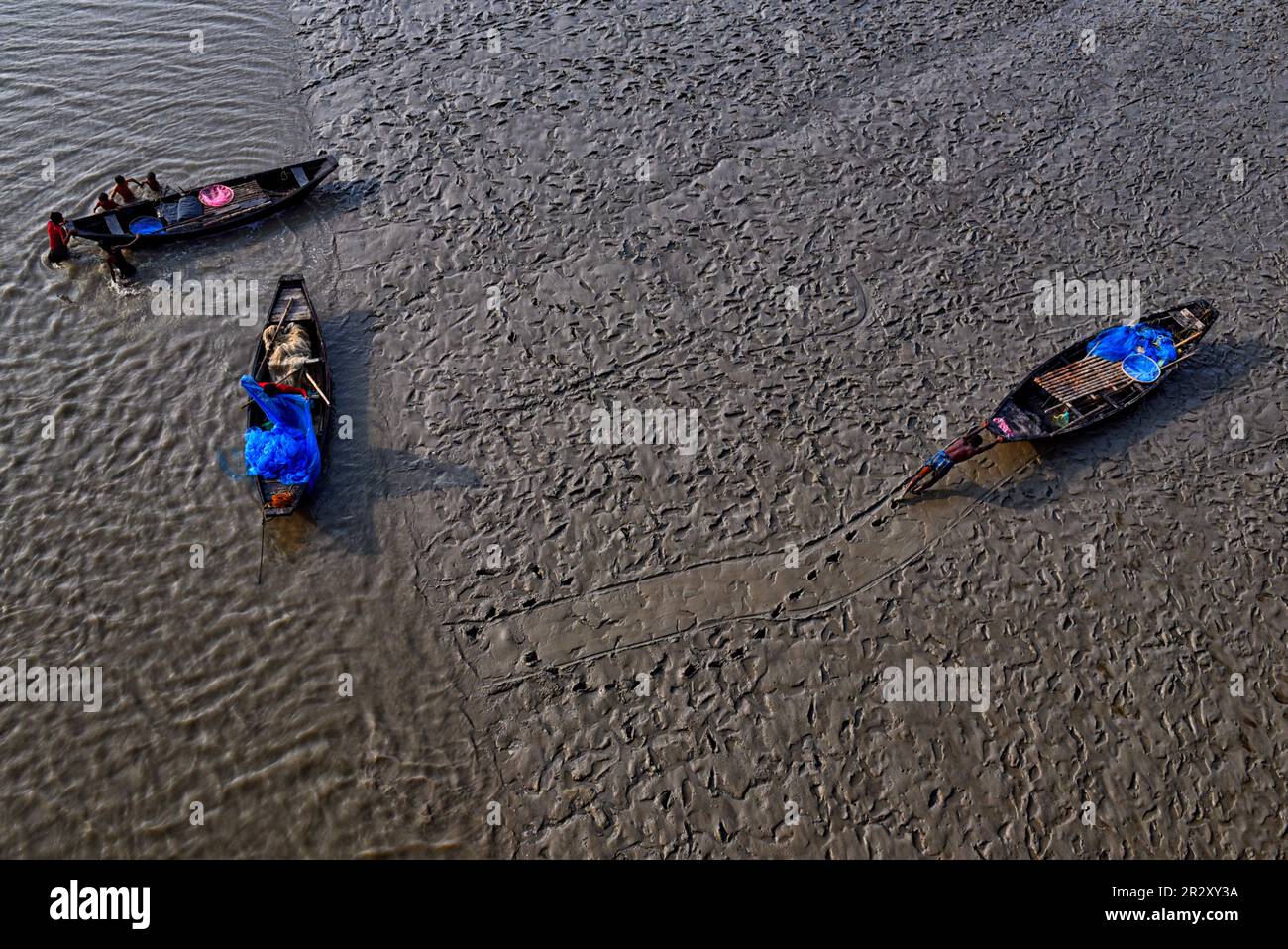 Canning, India. 21st May, 2023. Fishermen seen pushing their boat which ...