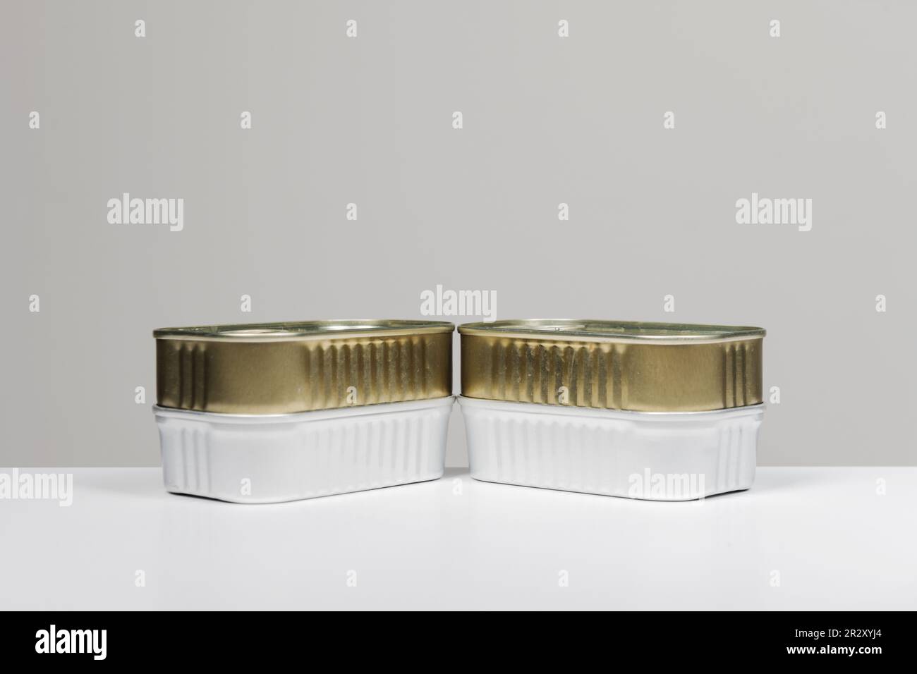 A stack of various metal canning tins on a plain white background Stock ...